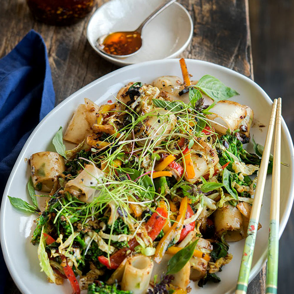 Fat rice noodles with chinese broccoli & black garlic in a red chile ...